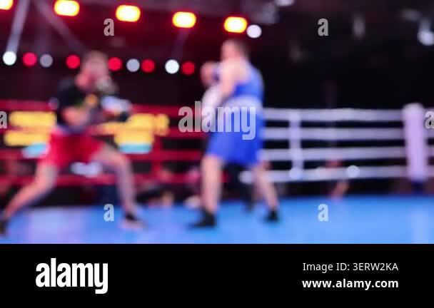 Blurred motion of two male boxers exchanging punches in the ring as a ...