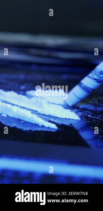 Unrecognized person is snorting line of white drug powder through ...