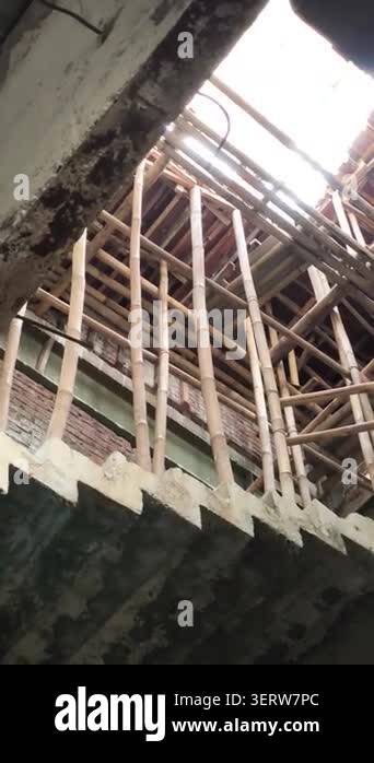 Low angle view of woven bamboo scaffolding structure supporting ...