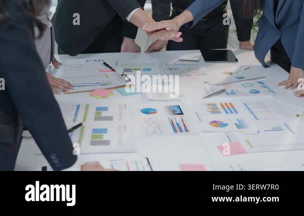 Business team hands collaborating on business documents and charts in ...