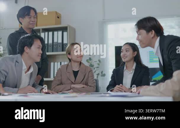 Business professionals discussing ideas around table in office Stock ...