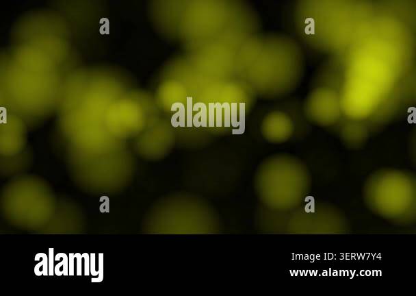 Animated dark background with soft, out-of-focus yellow and greenish ...