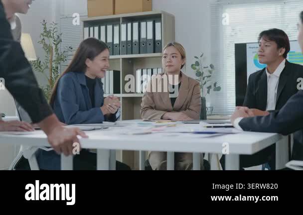 Business people discussing ideas around table in office Stock Video ...