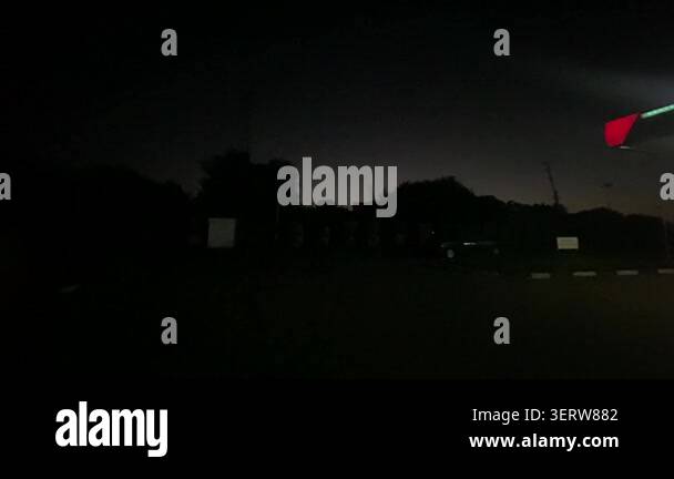Panning night shot towards a gas station in Lilongwe, Area 18, with ...