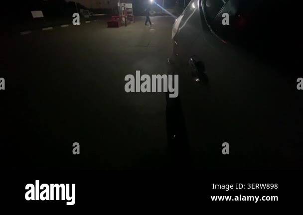 Panning night shot towards a gas station in Lilongwe, Area 18, with ...