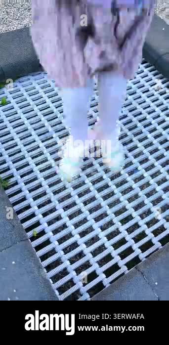 A top-down view of the legs of a little girl wearing white and blue ...