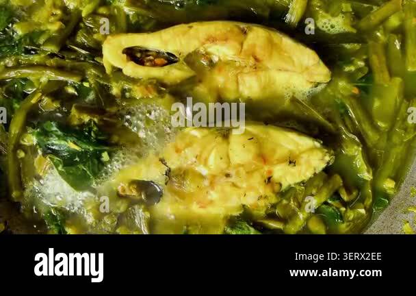 Cooking Thai fish curry with Yellow Velvet leaves in pan, Thai northern ...