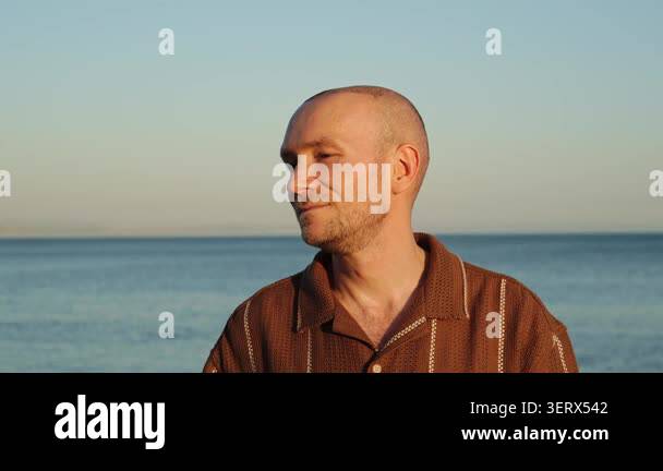 Portrait of a very happy, cheerfully smiling Caucasian man in a brown ...