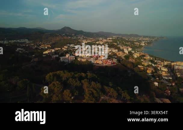 Aerial view of Malaga residential districts, green hills and ...