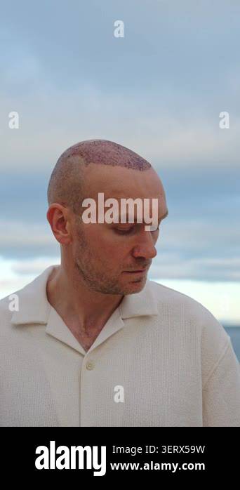 A frontal portrait of a serious and calm Caucasian man showing healing ...