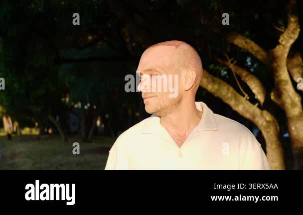 A portrait of a Caucasian man with a gentle, subtle smile showing ...
