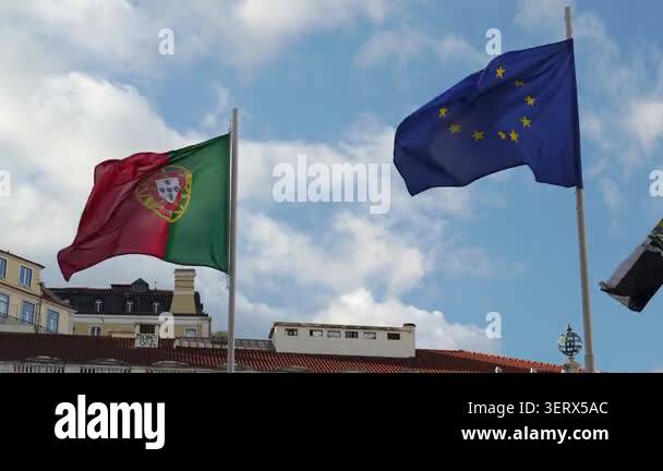 The national flag of Portugal, the European Union flag, and the ...