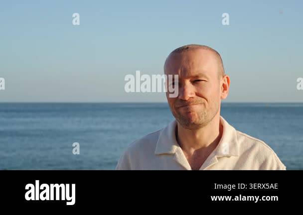 Mddle-aged man after a hair transplant procedure, looking at the camera ...
