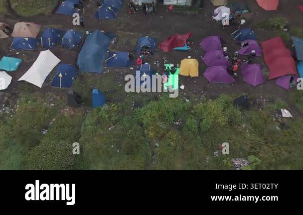 Aerial View of a Vibrant Campsite Surrounded by Nature and Tents in ...