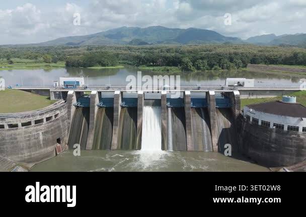 A Serene Landscape Featuring a Dam Overlooking Lush Greenery and ...