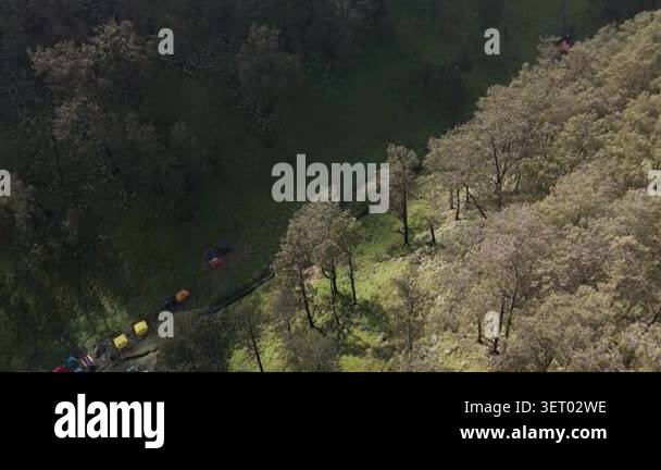Aerial View of Colorful Tents Camped in Lush Green Valley Surrounded by ...