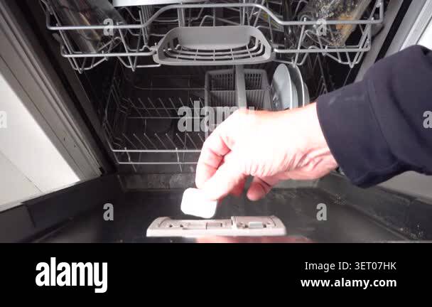 Stockholm, Sweden A man places a dish detergent pellet inside a ...