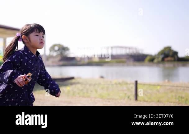 Child running near water body smiling happily Stock Video Footage - Alamy