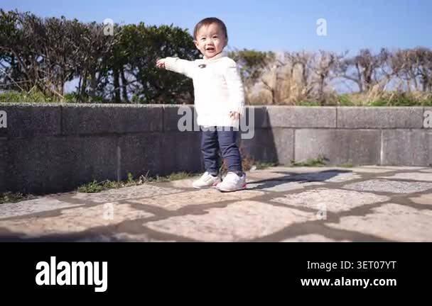 Happy child pointing while standing outdoors Stock Video Footage - Alamy