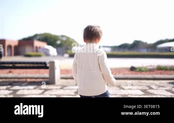 Child walking away near water body Stock Video Footage - Alamy