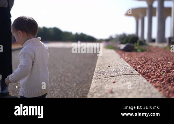 Small boy walking along gravel path Stock Video Footage - Alamy