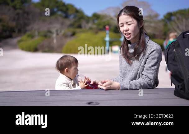 Woman sitting at table talking to child Stock Video Footage - Alamy