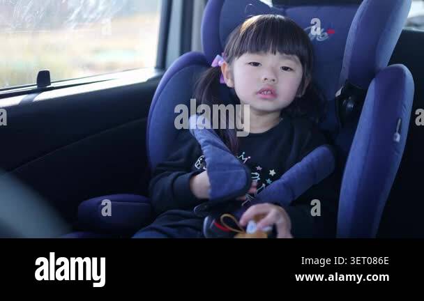 Young girl sitting in car seat looking thoughtful Stock Video Footage ...