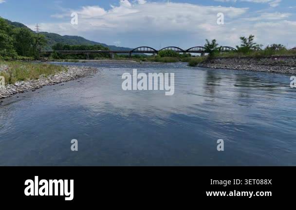 Calm river flowing under bridge Stock Video Footage - Alamy