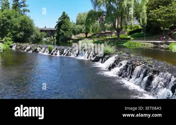 Arnoia River flowing peacefully through a picturesque city park in the ...