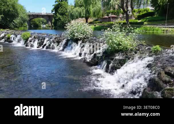 Beautiful waterfall on the Arnoia river flowing through a lush park in ...