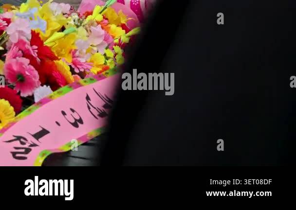 Bright condolence wreath on steps, colorful gerbera daisies and lilies ...