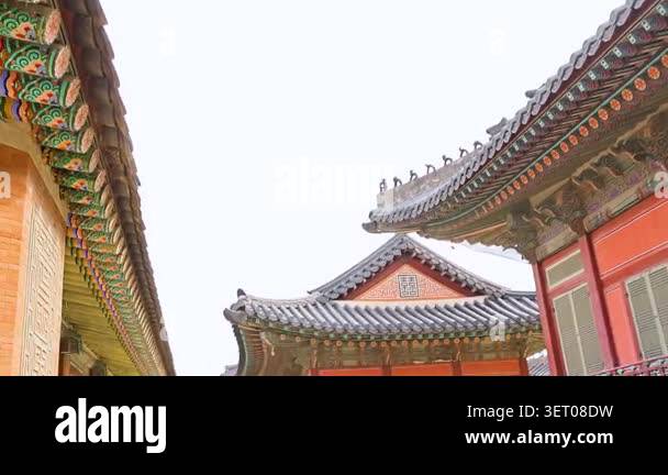 Closeup colorful eaves and roofline showing painted brackets, tile ...
