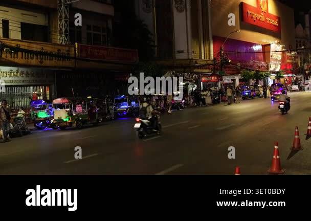 Night market street asian tuktuks crowd under neon, roadside stalls and ...