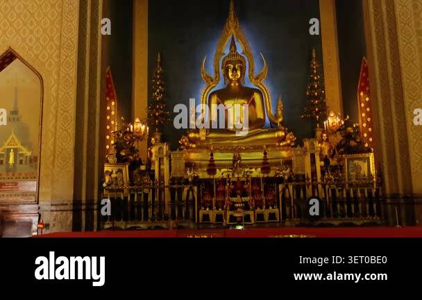 Majestic golden buddha seated shrine interior, illuminated halo ...