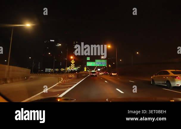 Night highway approach illuminated overhead signs and directional ...
