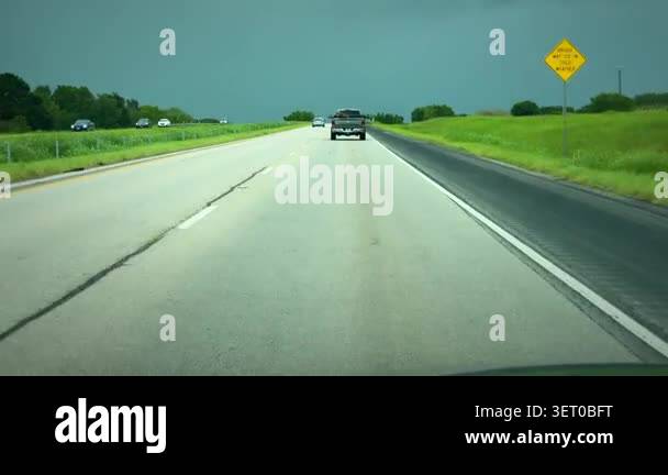 Dashboard view following pickup truck on twolane highway under ominous ...