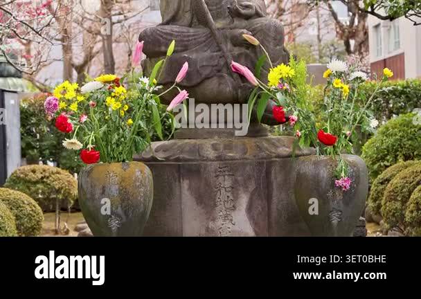 Tilt Up Jizo Statue Surrounded By Flowers Sensoji Temple Tokyo Japan ...