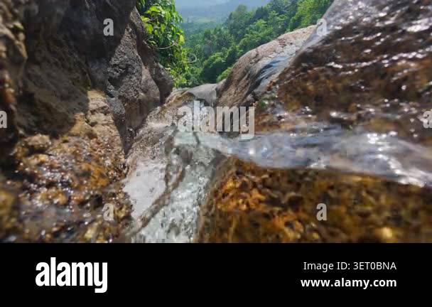 Close up of clear water flowing between granite rocks at Na Muang ...