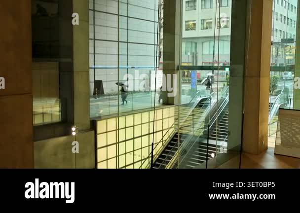 Modern Glass Building Interior With Escalators And Reflections. High ...