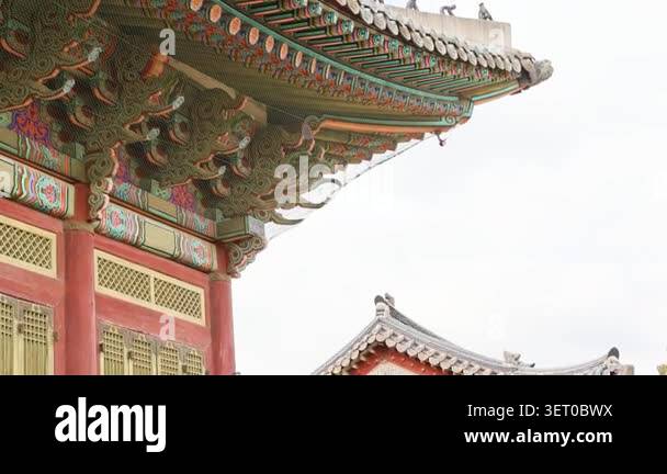 Closeup painted rafters and bracket arms with colorful motifs, carved ...