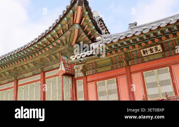 Ornate eaves with colorful painted beams and carved details, closeup of ...