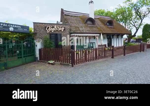 Tihany, Hungary - May 19, 2026: Traditional thatched-roof house with ...