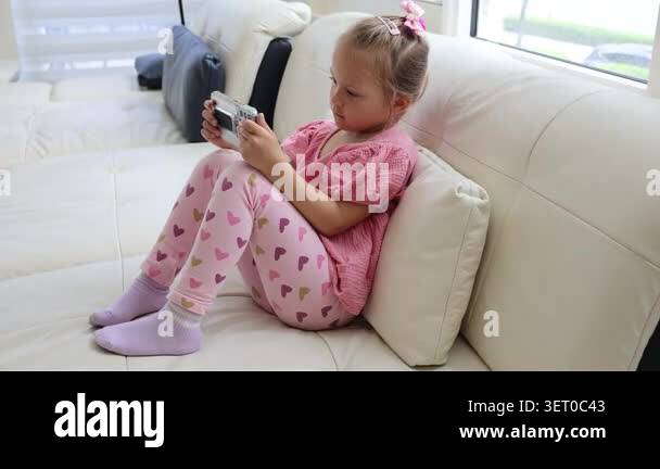 Detailed close-up of a mobile phone held by a young child. Technology ...