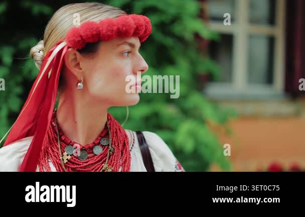 Beautiful young lady in authentic Ukrainian vyshyvanka and red floral ...