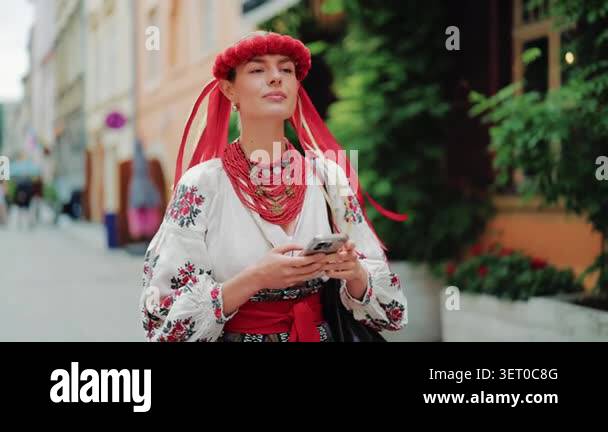 Smiling woman dressed in traditional Ukrainian vyshyvanka and red ...