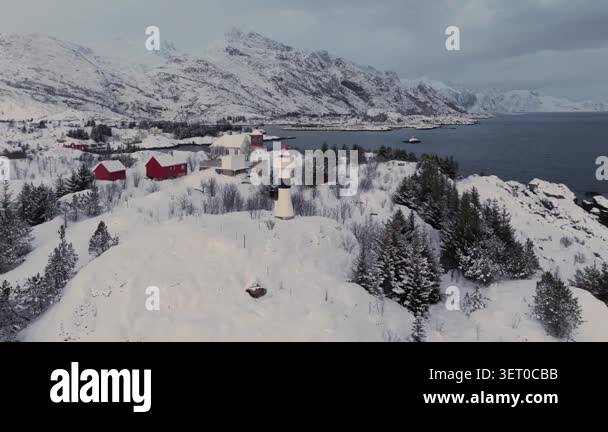 Birds-eye winter scene of a small coastal village dominated by a tall ...