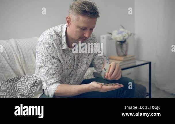 Young Man Counting Money Followed By Coins And Banknotes At Home Stock ...