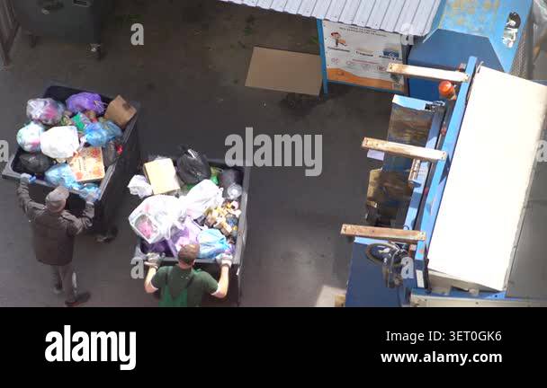 Workers on Duty with Garbage Containers Near a Truck for Waste ...