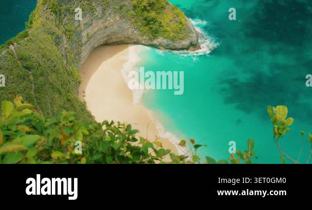 Tropical white sand cove surrounded by steep cliffs at Kelingking beach ...
