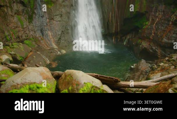 Costa Rica Catarata del Toro waterfall basin with moss covered stones ...